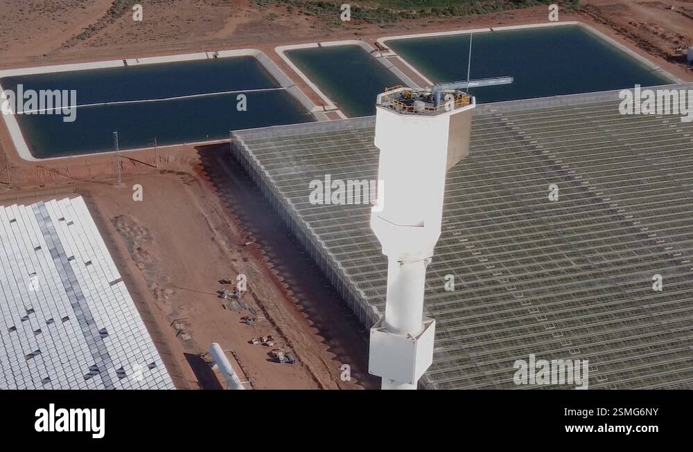 An aerial view of a solar thermal energy farm with thousands of mirrors ...