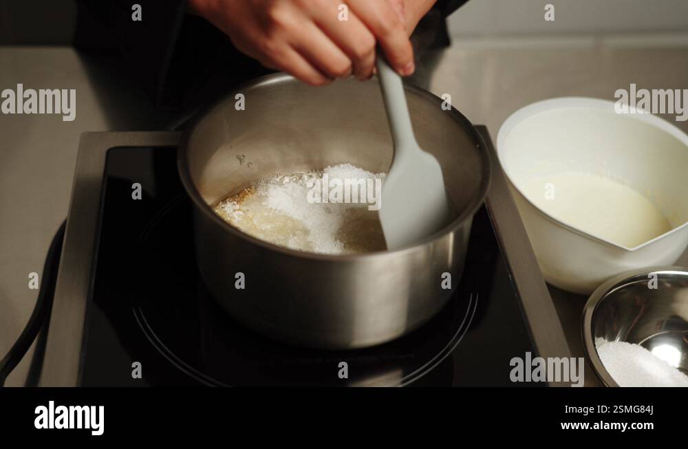 A confectioner melts sugar in a pan to prepare caramel Stock Video ...