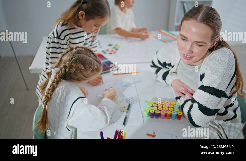 Painter lady teaching children drawing workshop closeup. Pupil teacher ...