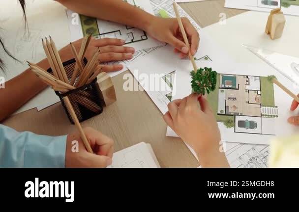 Architect and engineer use tree model discuss about building blueprint ...