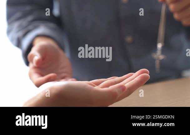 Slow motion handing over holy cross to the other as an act of catholic ...