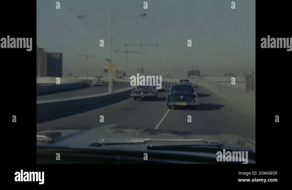 NEW YORK CITY 1970s: A car drives through traffic on an elevated ...