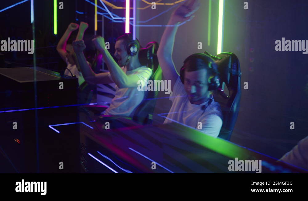 An e-sport team is celebrating the round win by giving each other high ...