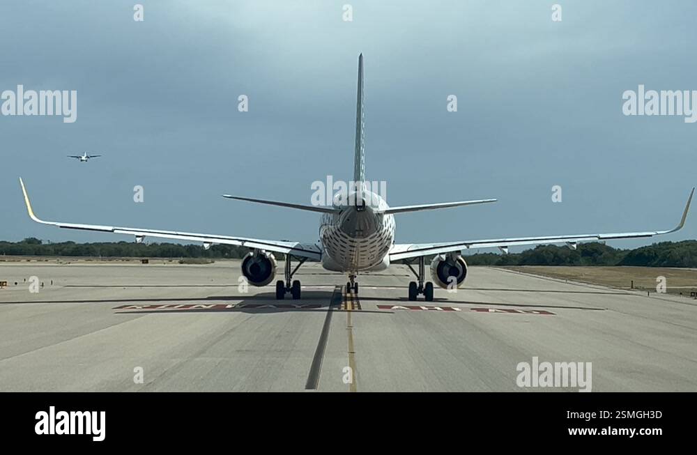 Close-up rear view of an A320 waiting for departure next ro the runway ...
