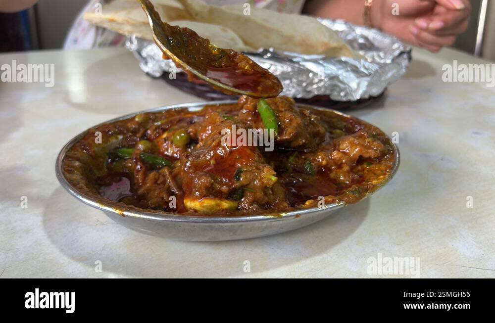 Spciy mutton curry prepared in Indian style served with tandoori roti ...