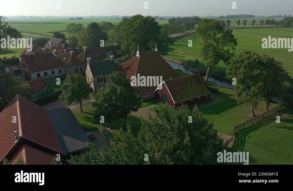 Aerial view of peaceful village with church, farm, and river ...
