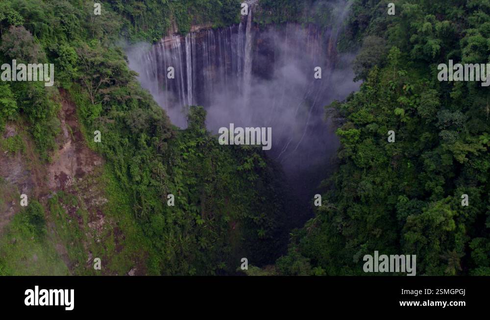 Aerial view of waterfall, forest, cliff in Tumpak Sewu, Indonesia Stock ...