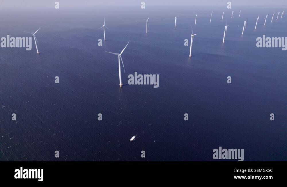 Aerial view of spinning windturbines in offshore wind farm, Netherlands ...