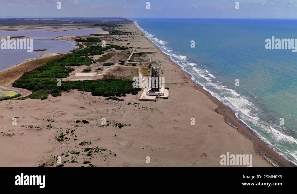 An aerial view of a long, narrow spit of land separating a salt lake ...