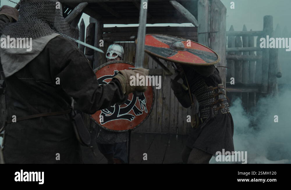 Knight Fighting against Two Enemies with Swords and Shields in Burning ...