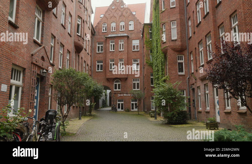 Scenic courtyard between historic brick buildings in Burghof Flensburg ...