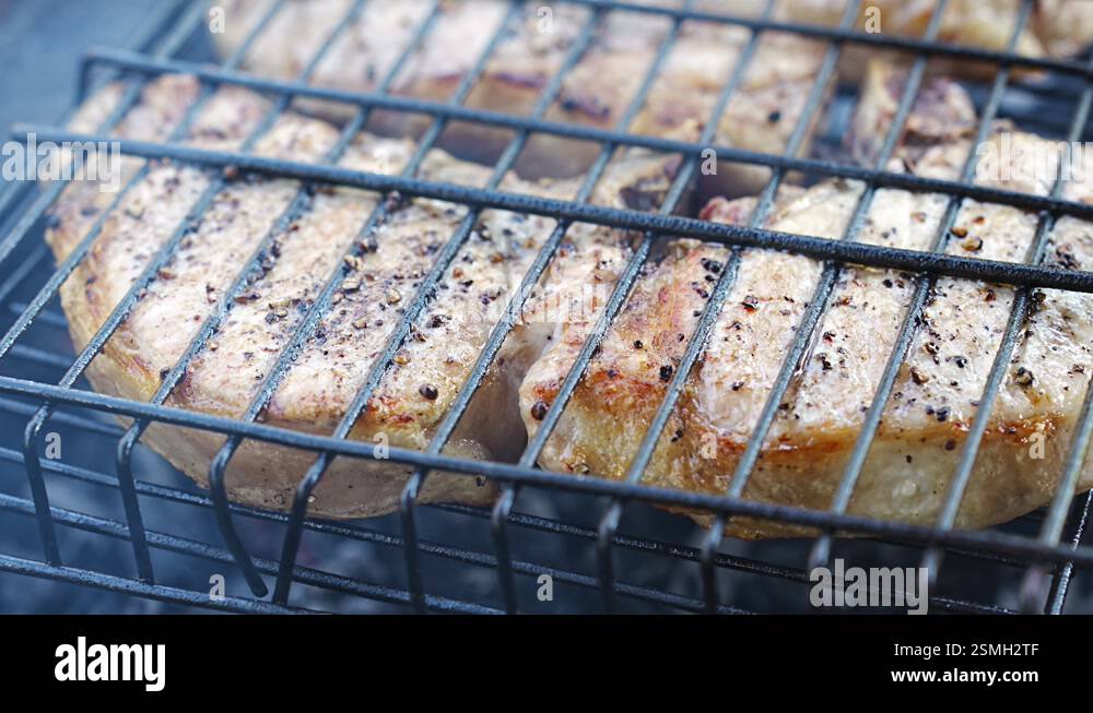 close-up. Cooking pork steak on a wire rack over an open fire Stock ...