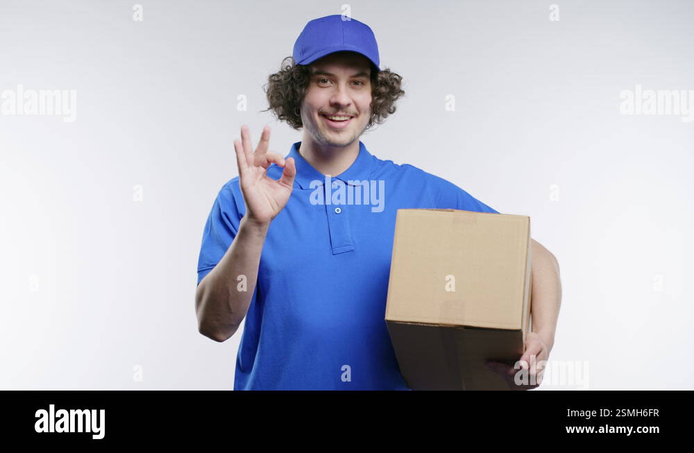 Positive postal courier man with hands sign OK, okay. Happy postman on ...