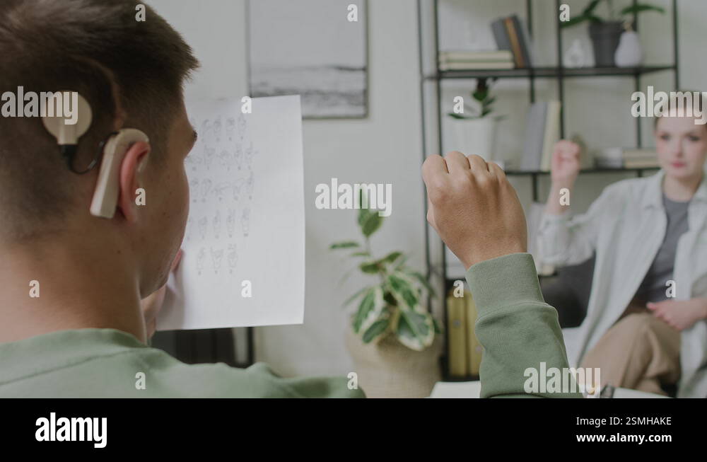 Young Deaf Man Learning Sign Language Alphabet with Female Teacher ...