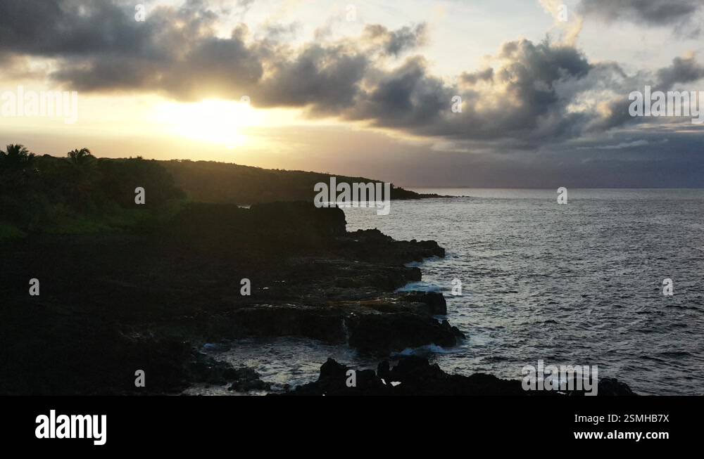 Sunset over Mermaid Ponds in Hawaii, with the sun casting golden Stock ...