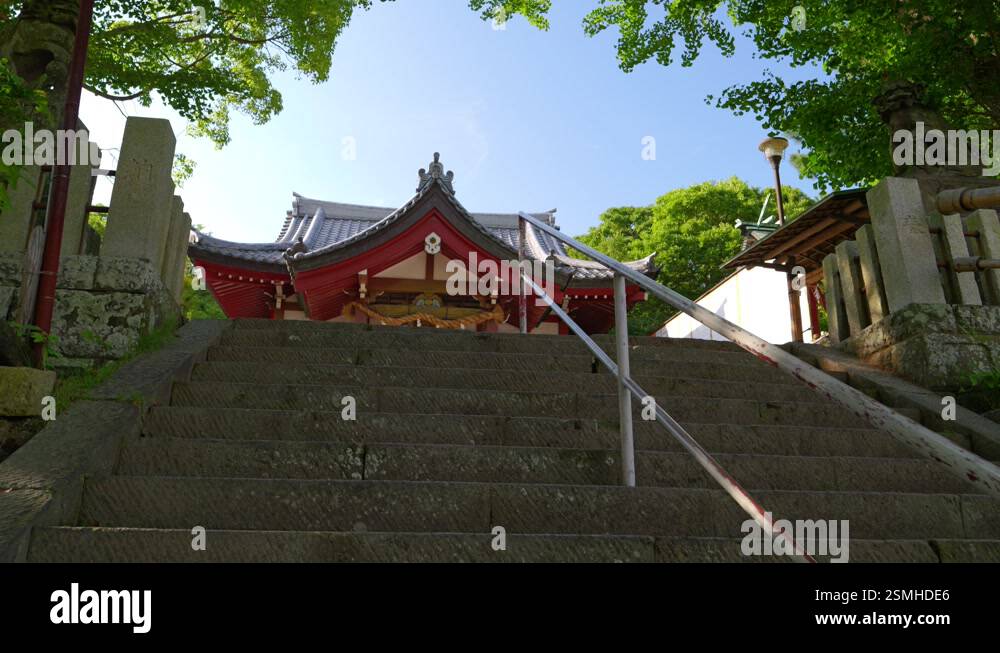 Slow motion walking up stone steps to typical shrine building in Japan ...