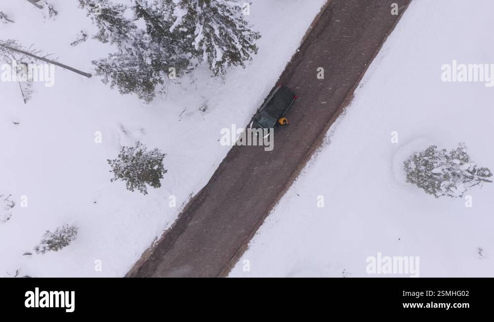 Man exiting and getting in car during snowstorm, Drone top shot Stock ...