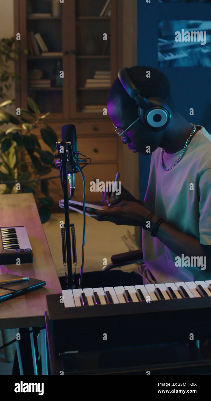 Musician Writing Notes and Preparing Mic at Home Recording Studio Stock ...