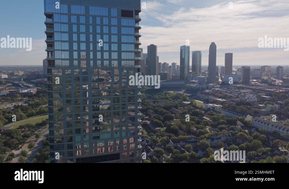 Reveal of Houston skyline behind Residences At The Allen building on a ...