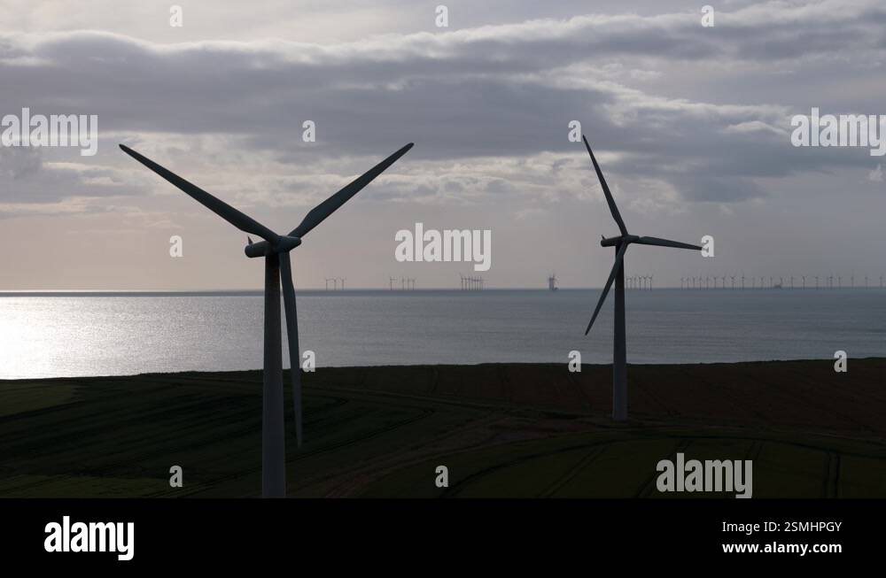 Drone Aerial footage of a wind turbine, windmill turning in the wind on ...