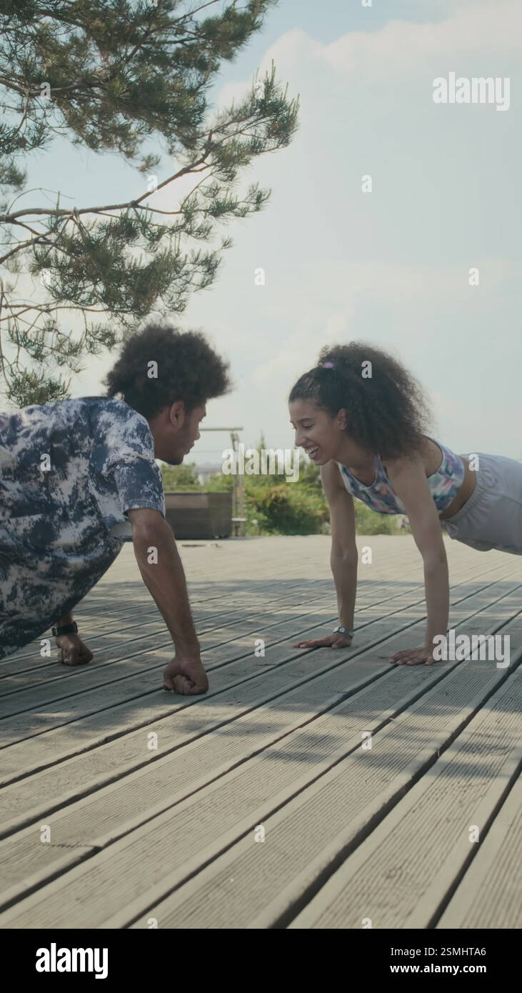 Strong Couple Performing Push-Ups with High Fives during Outdoor ...