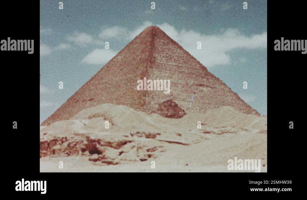 Egypt 1950s: Pyramids of Giza. Men climb the face of the pyramid. Man ...