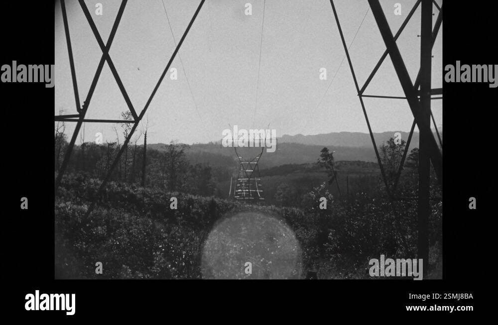 1940s: Black and white film footage of power lines extending into the ...