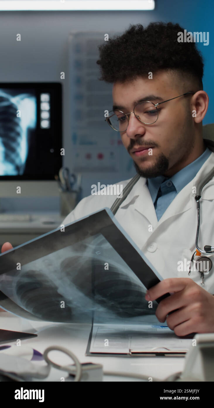 Vertical of Young Doctor Decoding Chest X-Ray to Patient during ...
