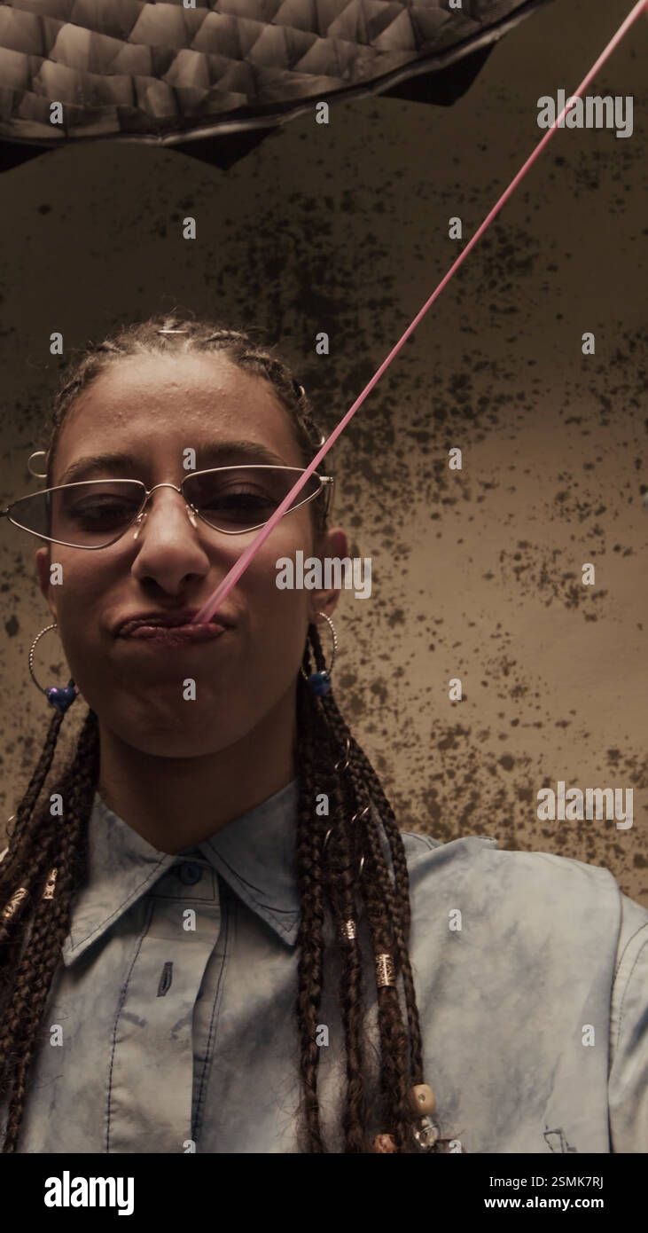 Vertical of Biracial Girl Pulling Chewing Gum out of Her Mouth Stock ...