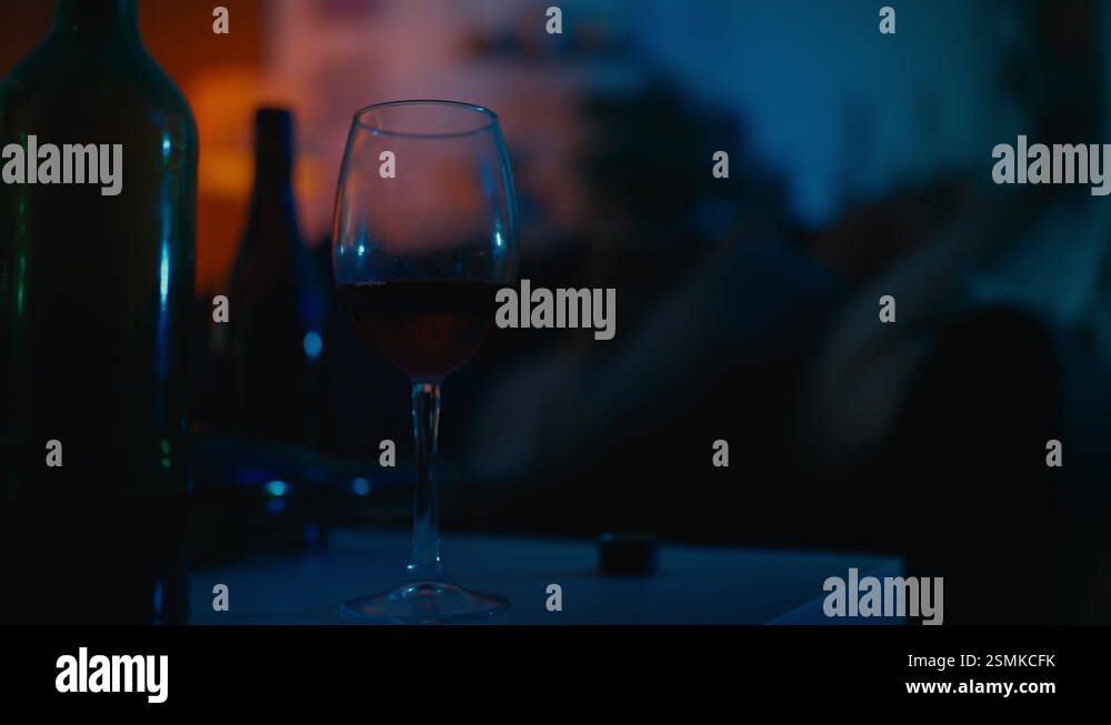 Glass of wine standing on desk, drunk woman sleeping on couch, alcohol ...