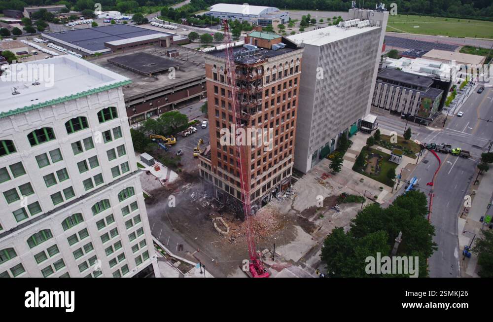 An aerial perspective capturing the demolition of a high-rise building ...