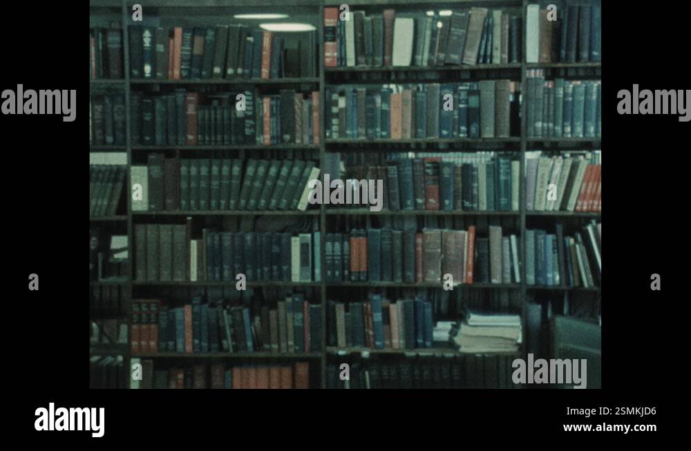 1960s: rows of library books on tall shelves, most vertical, some ...