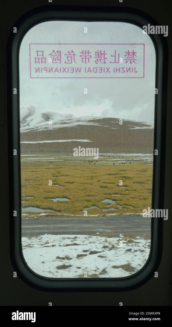 VERTICAL: Oval shaped train window offers a stunning view of the snowy ...