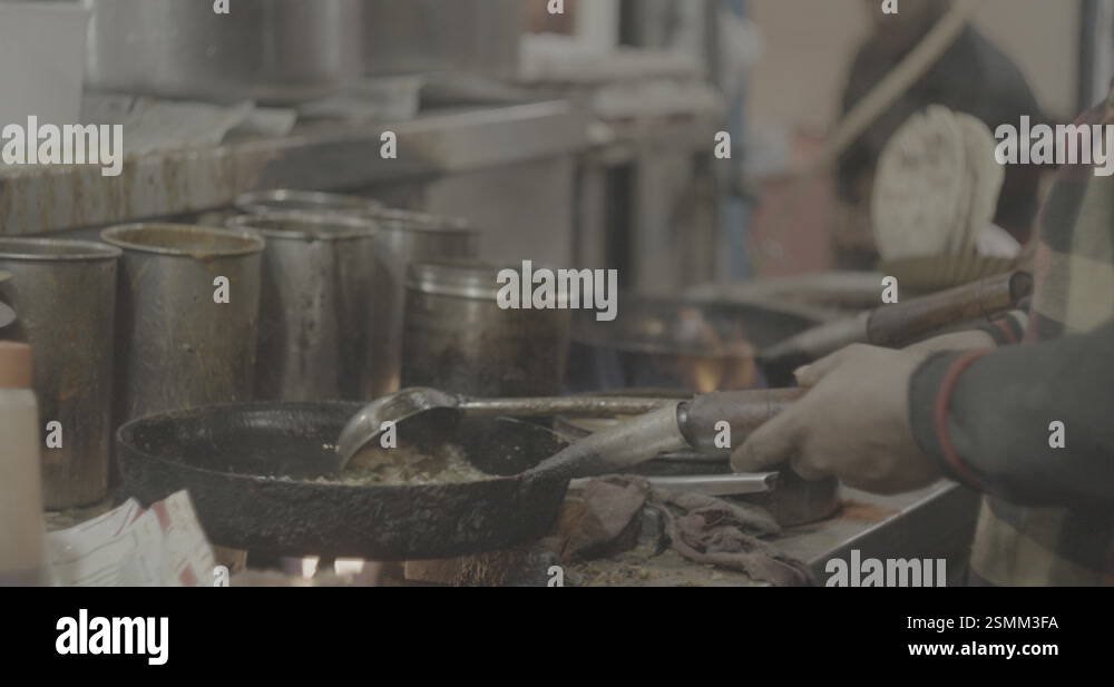 Man cooking street food Biryani on a busy street. Slow motion Biryani ...
