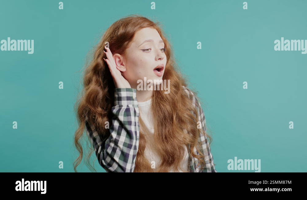 Curious ginger woman doesn't hear, asking what. Quiet sound, deaf ...