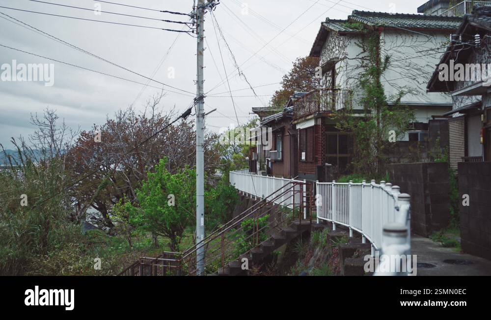 Traditional Japanese houses on a hillside pathway in Saikazaki with ...