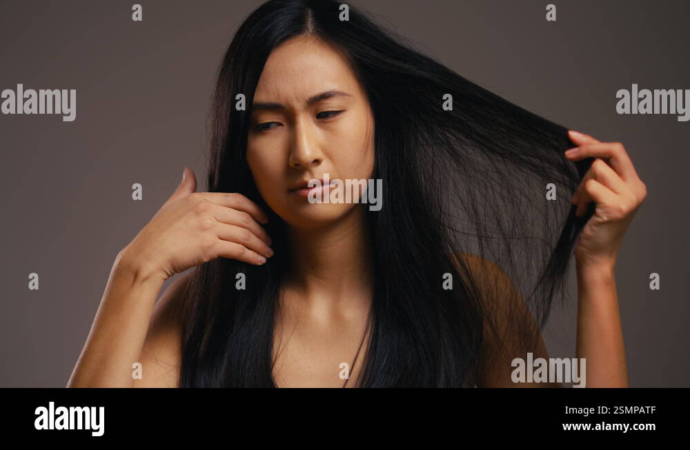 Young Korean woman upset with bad hair condition, suffering hair loss ...