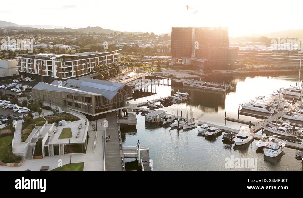 Drone orbit right above marina and waterfront buildings of Shell Cove ...