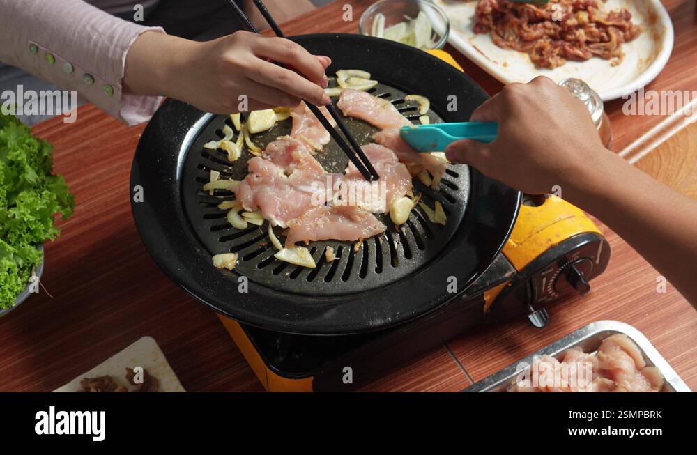Woman and Man Grilling Chicken Fillet Slice Together For Making Korean ...