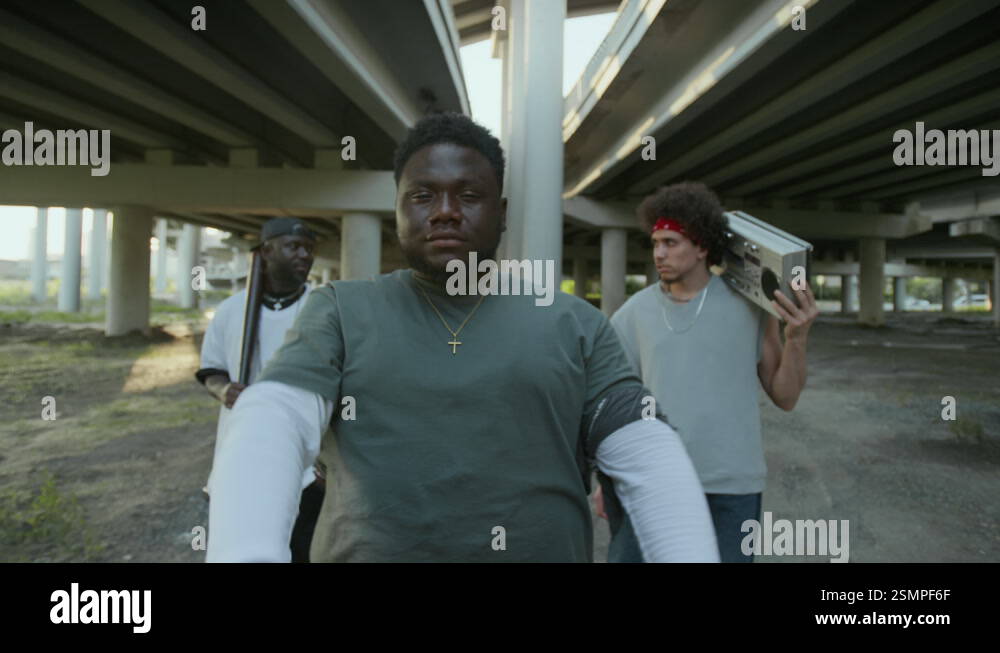 Black Man Showing Hip Hop Hand Gestures while Posing with Friends on ...