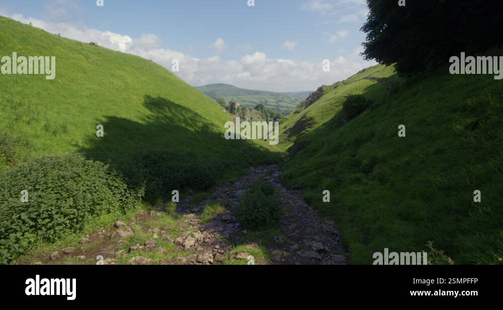 Extra wide shot off the limestone cliffs midway at cave Dale with path ...