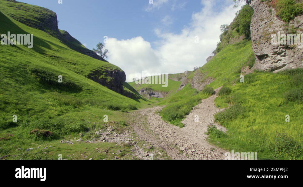 tilting down shot looking South up the path in cave Dale, Castleton ...
