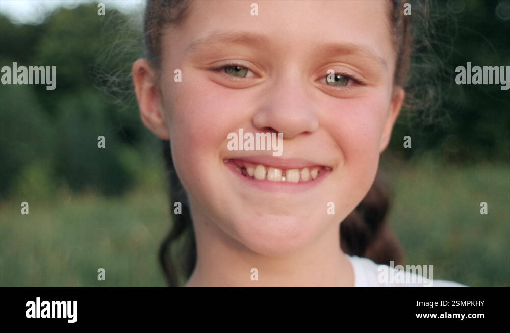Close up portrait of happy preteen girl kid looking at camera during ...