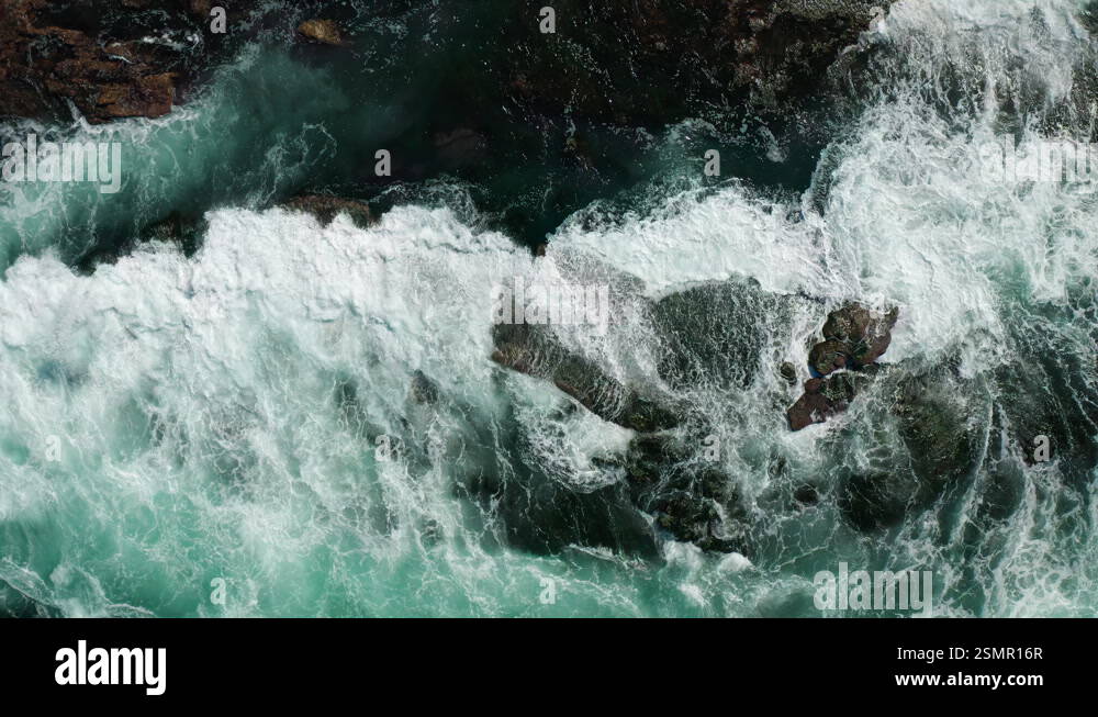Bird's Eye View - Waves Crash into Large Partially Submerged Boulder in ...