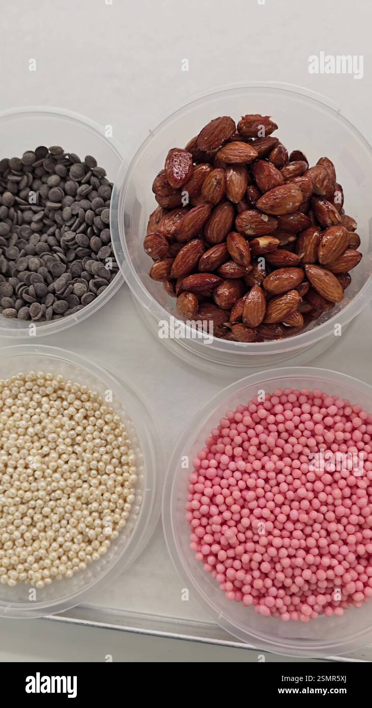 Various types of sprinkles are arranged as toppings on cakes and ...