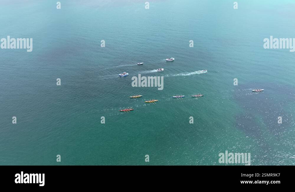 Aerial shot overhead rowing boats leaving marks in the water from ...