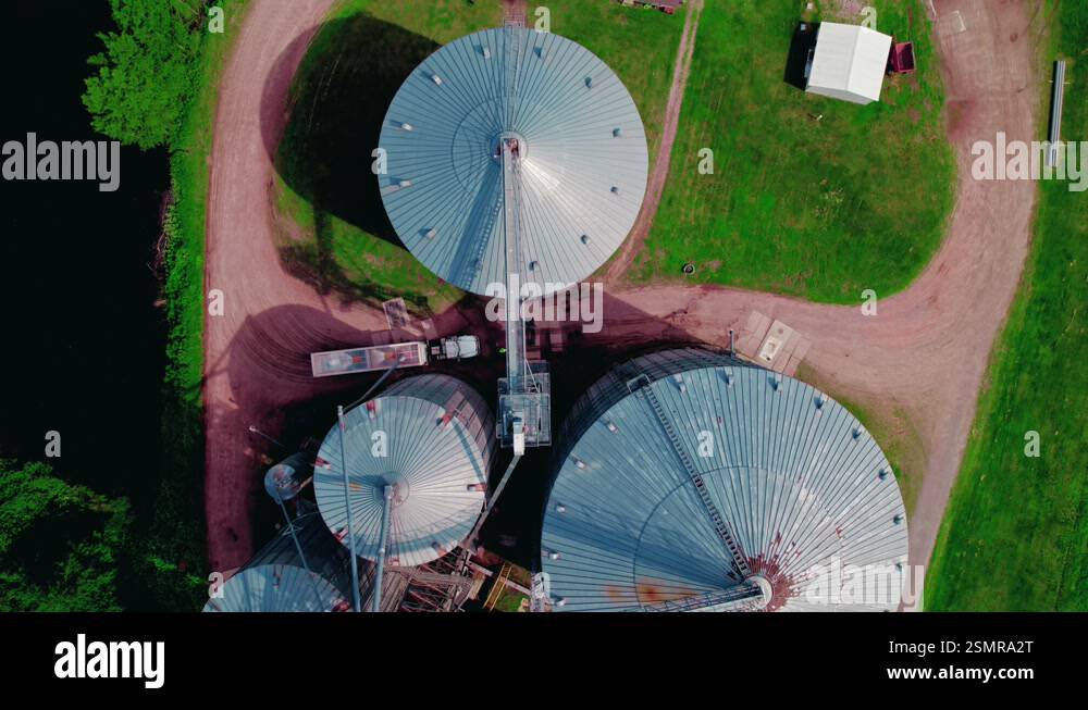 Grain trailer semi truck is loading from a silo farm in Wisconsin, USA ...