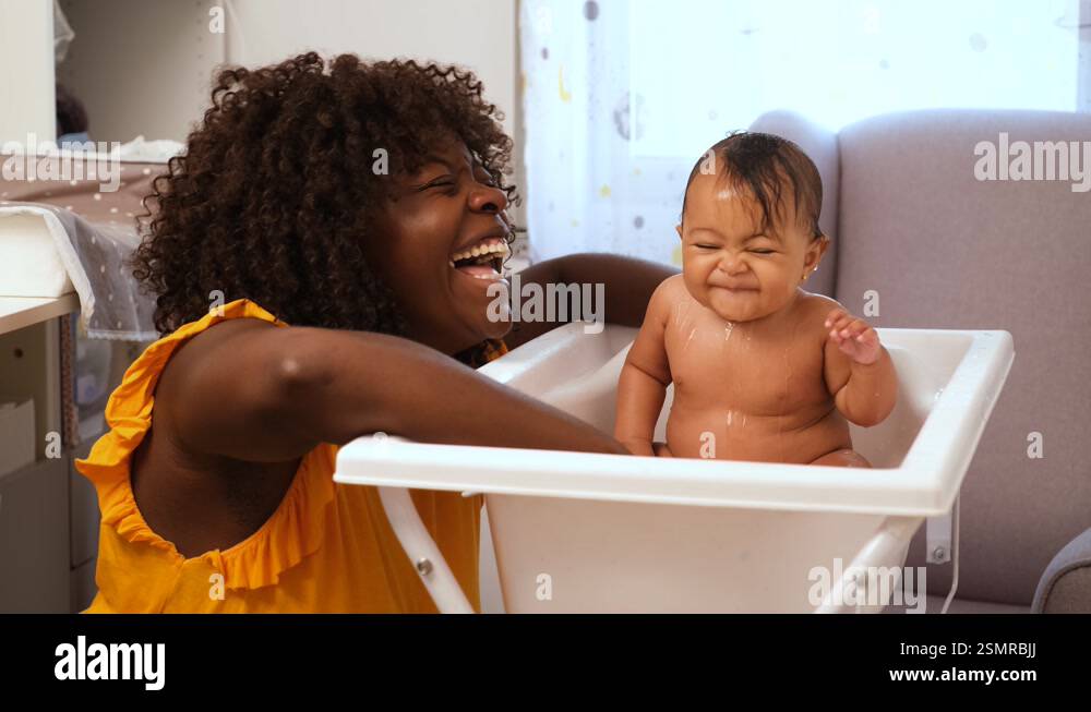 Mother washing her baby in a small bathtub Stock Video Footage - Alamy