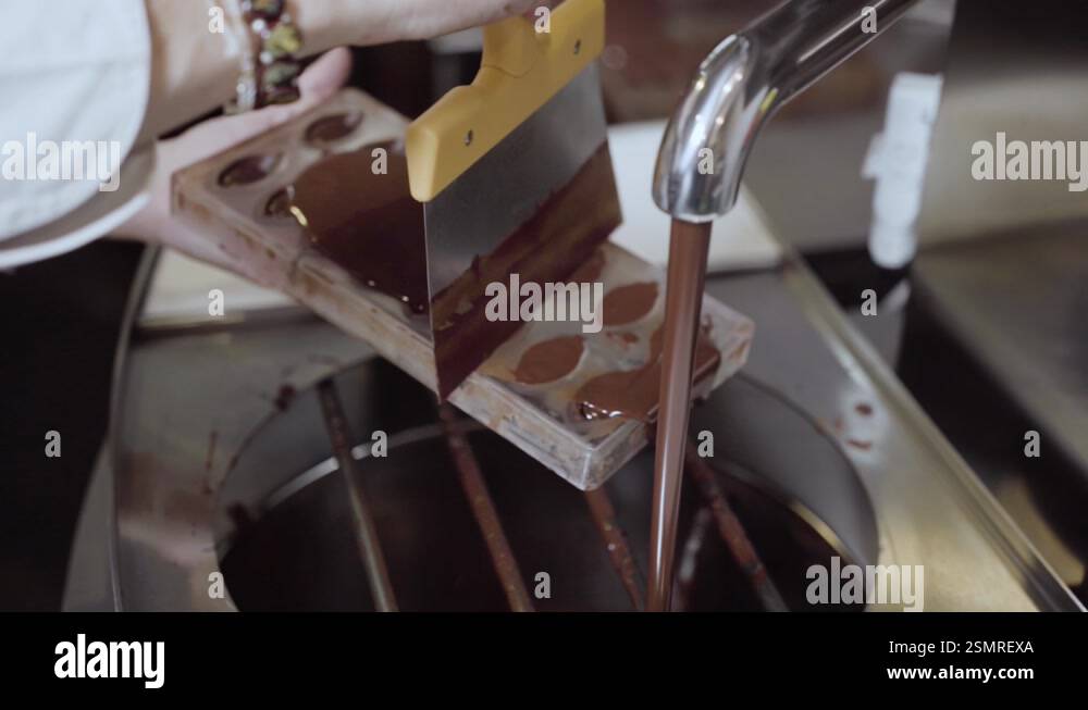 Chocolatier Scrapes Off Excess Melted Chocolate From Mould Surface ...