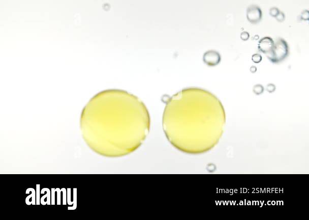 Capsule pills, Omega 3 gold oil capsules. Macro shot of Pills falling ...